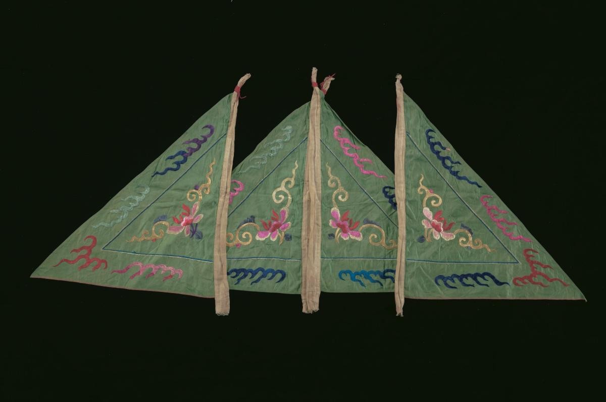 A light green pennant with floral embroidery worn by a ‘wu sheng’ in a ...